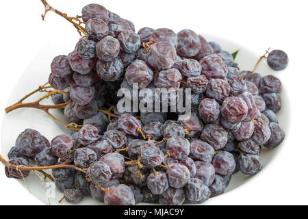 Detailed view of bunch of raisins over white Stock Photo - Alamy