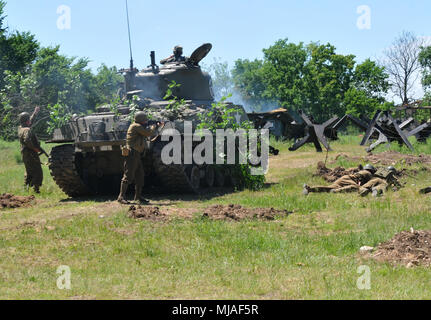 Reenactors put on a show in front of military and civilians during the ...