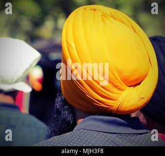 Sikh man wearing yellow dastar India. Sikh turban article of faith ...