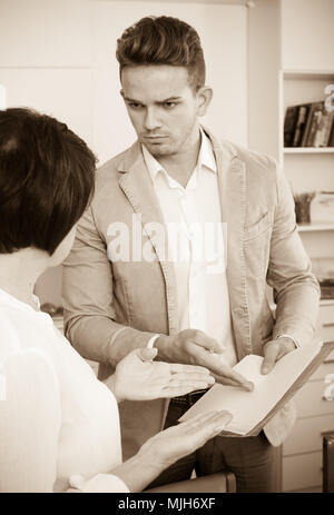 Elderly woman tries to persuade young man don't worry Stock Photo - Alamy