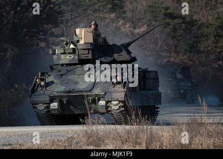 A company of armored cavalry assault vehicles, bristling with light and ...