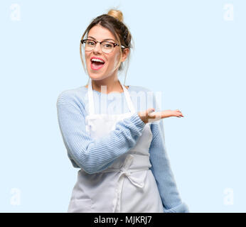 happy woman in apron with empty plate in kitchen Stock Photo - Alamy