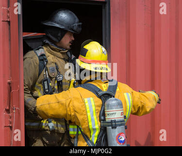 Civilians with Camp Pendleton Fire Department fill up a cooler with ...