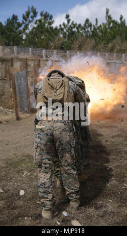 U.S. Marines from different units construct an oval charge during an ...