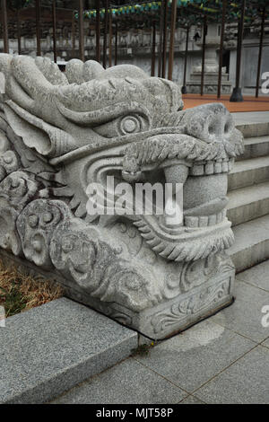 A huge dragon carved in stone, with an orb or yeouiju, in its mouth ...