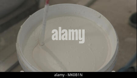 stirring putty in the bucket Stock Photo - Alamy