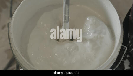 stirring putty in the bucket Stock Photo - Alamy