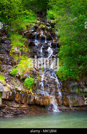 A small waterfall and boulder view Stock Photo - Alamy
