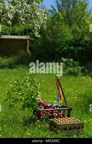 A handcart with colorful ribbons on a wonderful spring meadow for ...