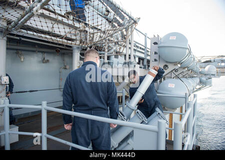 Cryptologic Technician loads an MK-214 seduction chaff canister into a ...