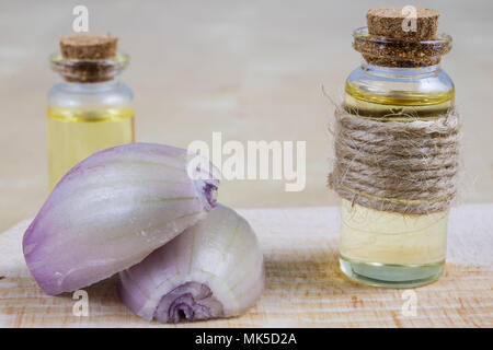 Syrup of onion in a small vial on a wooden table. Flu medicine in a ...