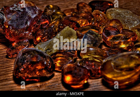Fossil Amber displayed on Wood Table Stock Photo - Alamy