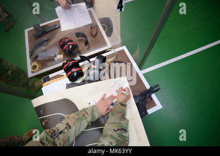 An alternate M9 pistol qualification course scorecard, magazines, an M9 ...