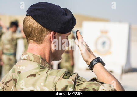 A member of the Royal British Navy salutes to show respect to fallen ...