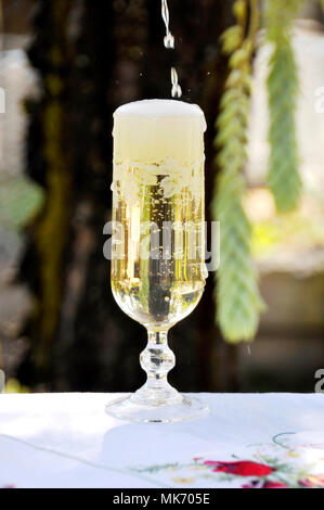 OVER FLOWING GLASS OF CHAMPAGNE Stock Photo - Alamy