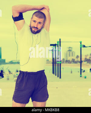 Young athletic man flexing his leg muscles before a long run Stock ...