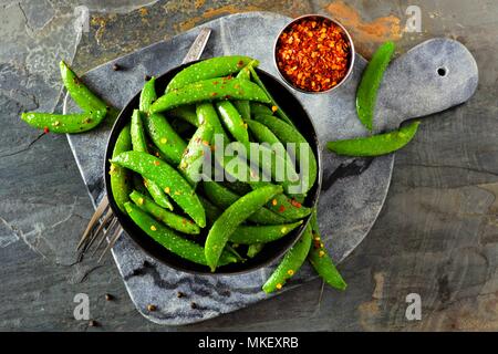 Sugar Pea, Snow peas on plank wooden background Stock Photo - Alamy