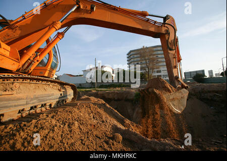 Large tracked digger diggers heavy plant machinery excavating soil on ...
