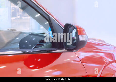 Fragment of the front-side part of a modern passenger car in the sales ...