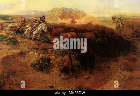 Buffalo hunt chase. A plains Indian on horseback shoots at a buffalo ...