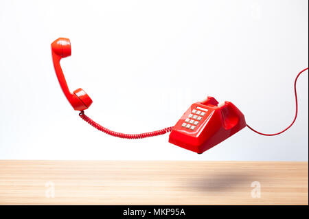 Urgent call waiting , classic red telephone receiver, old telephone on ...