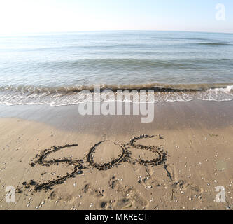 big text SOS on the sand of the beach in summer Stock Photo - Alamy