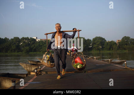 Ganzh, China. 9th May, 2018. Local people walk on the ancient pontoon ...