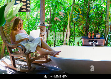 woman on laptop in bathroom Stock Photo - Alamy