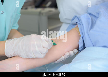 Needle being inserted into arm Stock Photo - Alamy