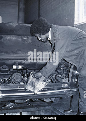 1970s, historical, inside a car repair workshop, two garage mechanics ...