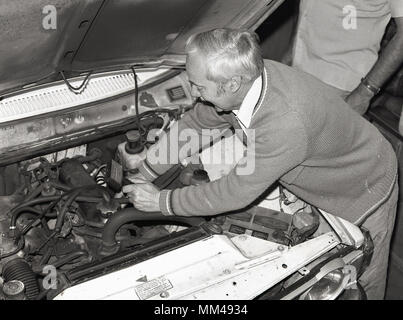 1970s, historical, inside a car repair workshop, two garage mechanics ...