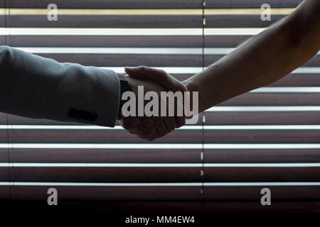 Lets shake on it. two unrecognizable women shaking hands in the studio ...