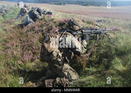 Soldiers take cover behind a berm after making contact with the enemy ...