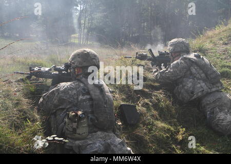 Soldiers take cover behind a berm after making contact with the enemy ...