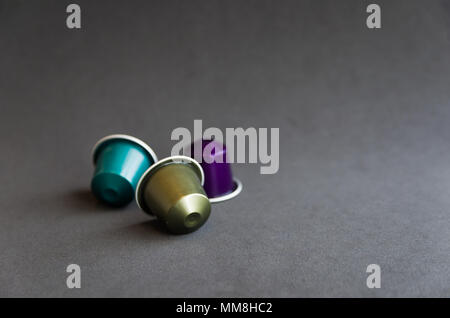 Beautiful colored coffee capsules on light blue background Stock Photo ...