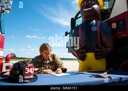 Col. Jennifer Short, 23d Wing commander, tightens a gas mask, April 30 ...