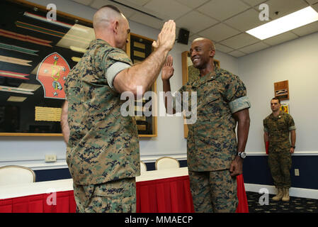 Lieutenant Col. James A. Ryans II (left) congratulates the new ...