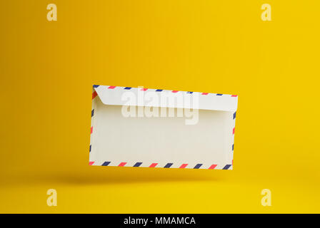 Envelope falling on the ground, yellow background with negative space ...