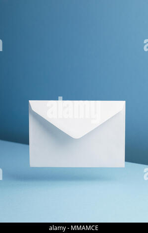 Envelope falling on the ground, blue background Stock Photo - Alamy