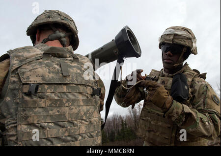 Army Staff Sgt. Kiatwain Andres observes as Staff Sgt. David Riley ...