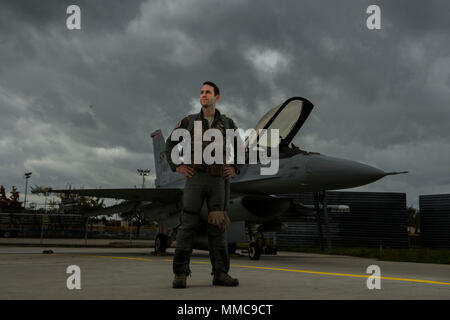 Capt. Tyler Brummer, 480th Fighter Squadron F-16 Pilot, stands next to ...