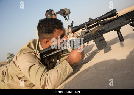 An Iraqi soldier fires an M14 sniper rifle as an Australian soldier ...