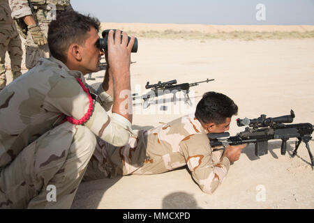 An Iraqi soldier fires an M14 sniper rifle as an Australian soldier ...