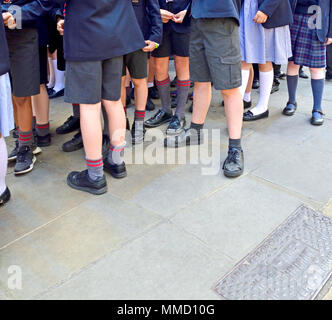 London, England, UK. Primary school children in blue uniform walking ...