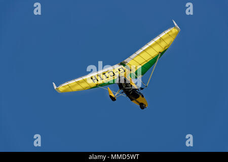 A microlight aircraft flying at Popham airfield in Hampshire in England ...