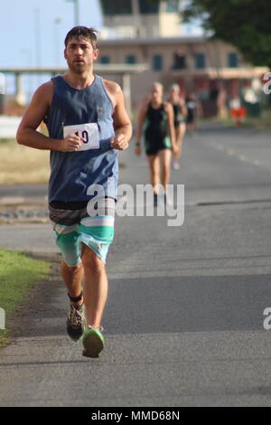 A race participant crosses the finish line during the 19th Annual USO ...