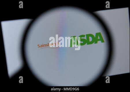 The Sainsbury's and Asda logos seen through a magnifying glass Stock ...
