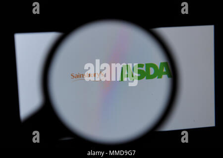 The Sainsbury's and Asda logos seen through a magnifying glass Stock ...