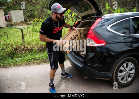 Ricardo Declet, a volunteer from San Juan, Puerto Rico, walks a box of ...