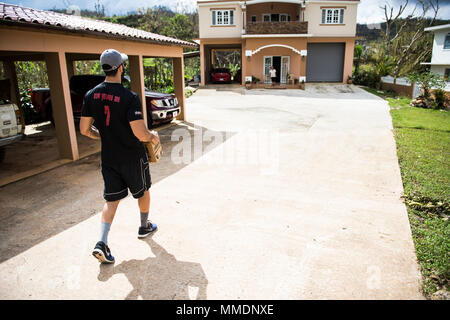 Ricardo Declet, a volunteer from San Juan, Puerto Rico, walks a box of ...